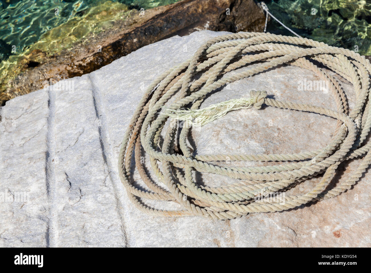 rope on a rock by the sea, close up Stock Photo - Alamy
