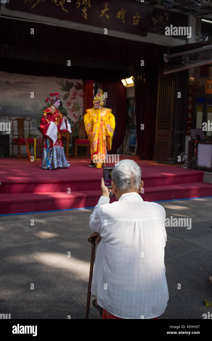 guangzhou,china - Aug,16,2017: Old man watching contonese opera show ...