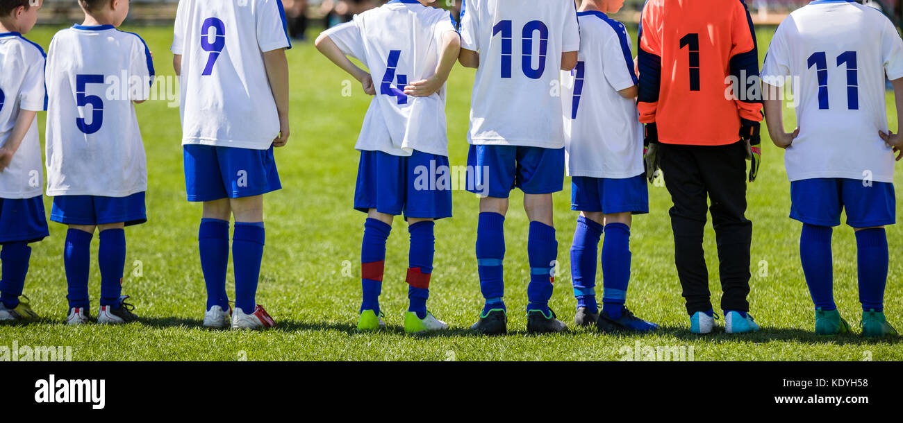 Children soccer players in a row. Football match for children. Training ...