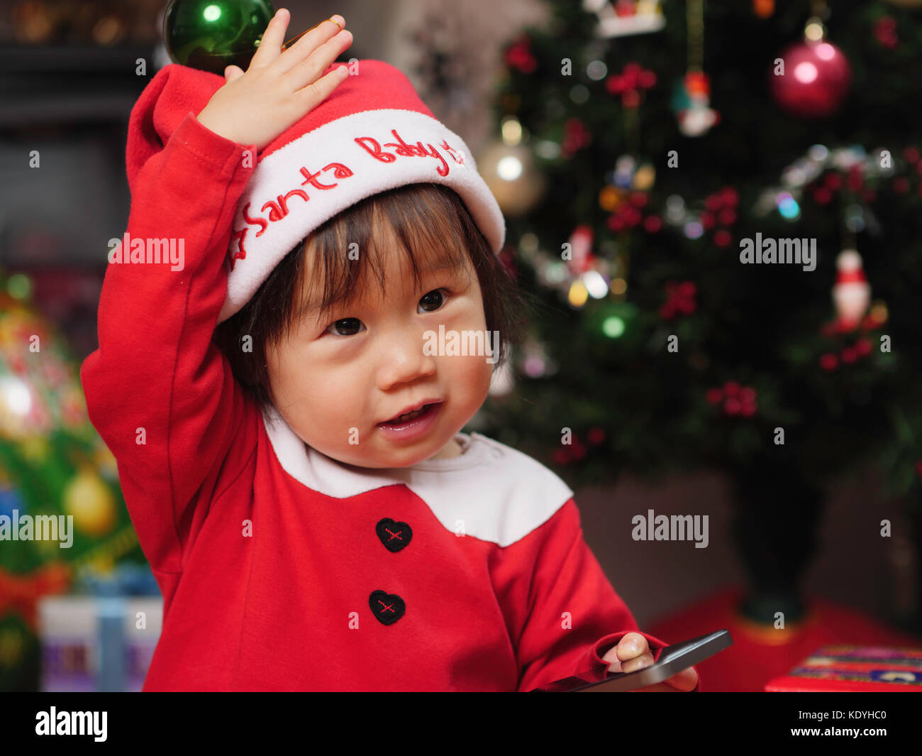 happy santa baby girl at home Stock Photo - Alamy