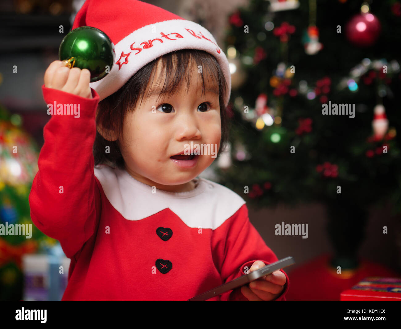 happy santa baby girl at home Stock Photo - Alamy