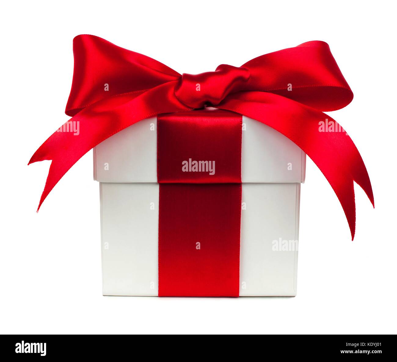 White gift box wrapped with vibrant red bow and ribbon isolated on ...