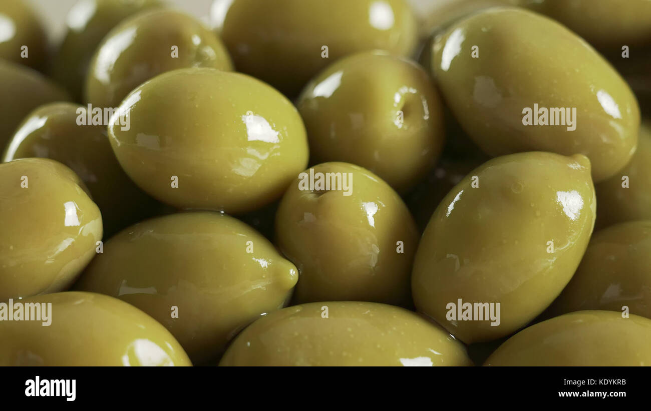 Large shiny green olives macro background Stock Photo - Alamy
