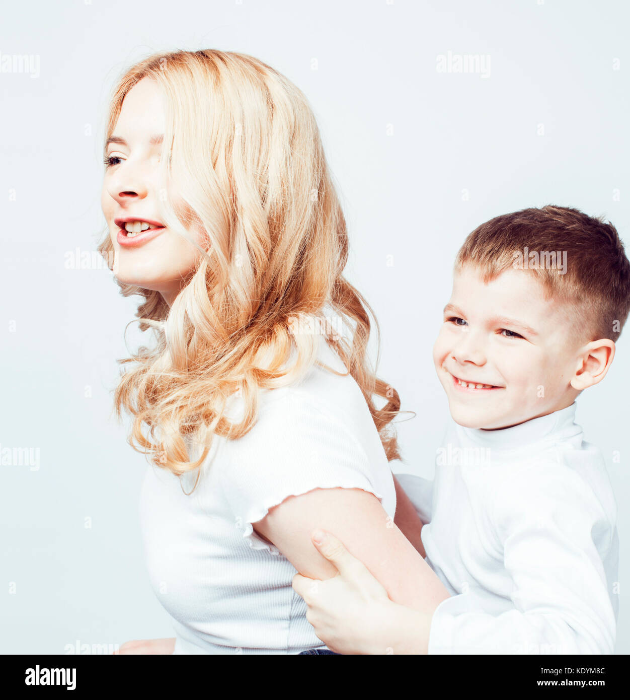 young modern blond curly mother with cute son together happy smiling ...