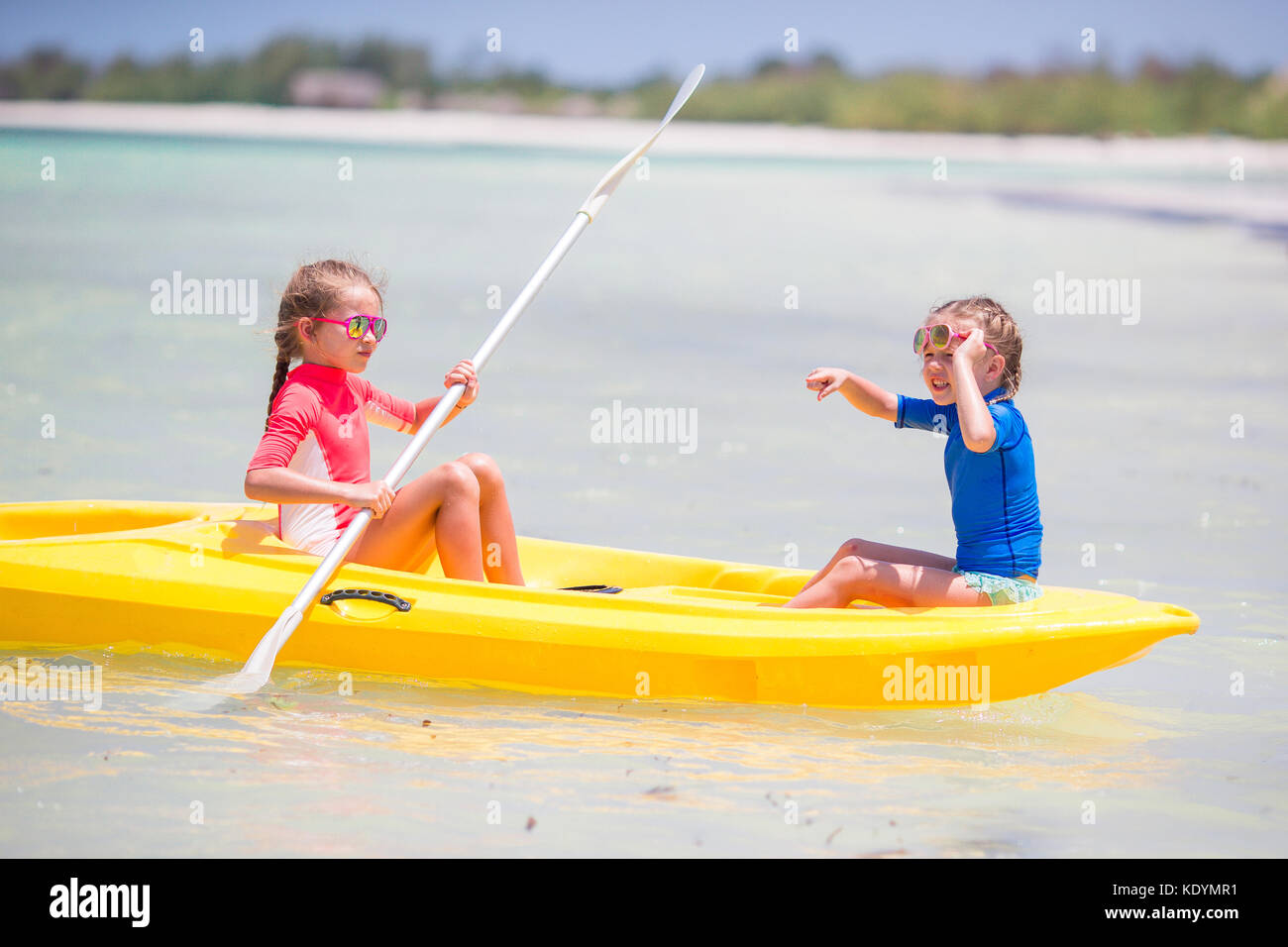 Little cute girls kayaking in the clear blue sea Stock Photo - Alamy