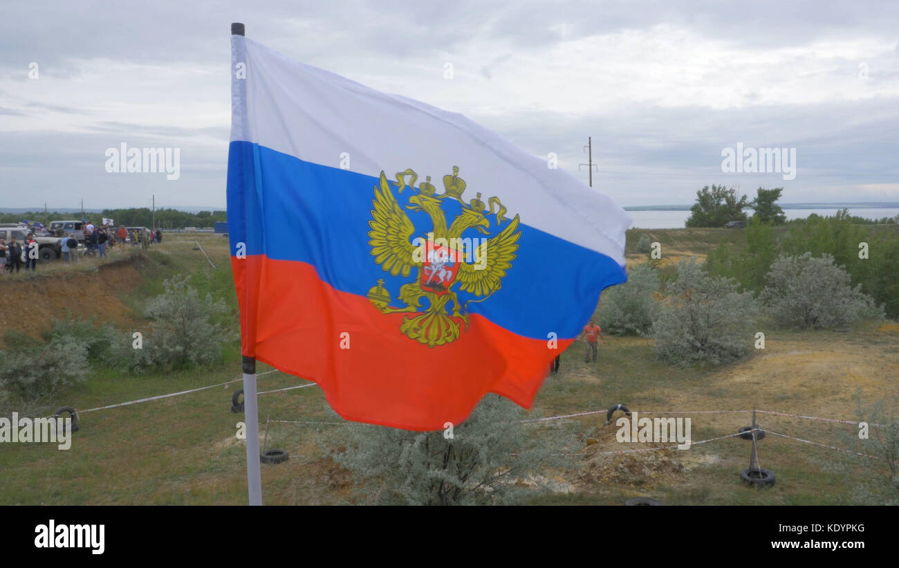 Russian flag waving in the wind on a background of mountains and nature ...