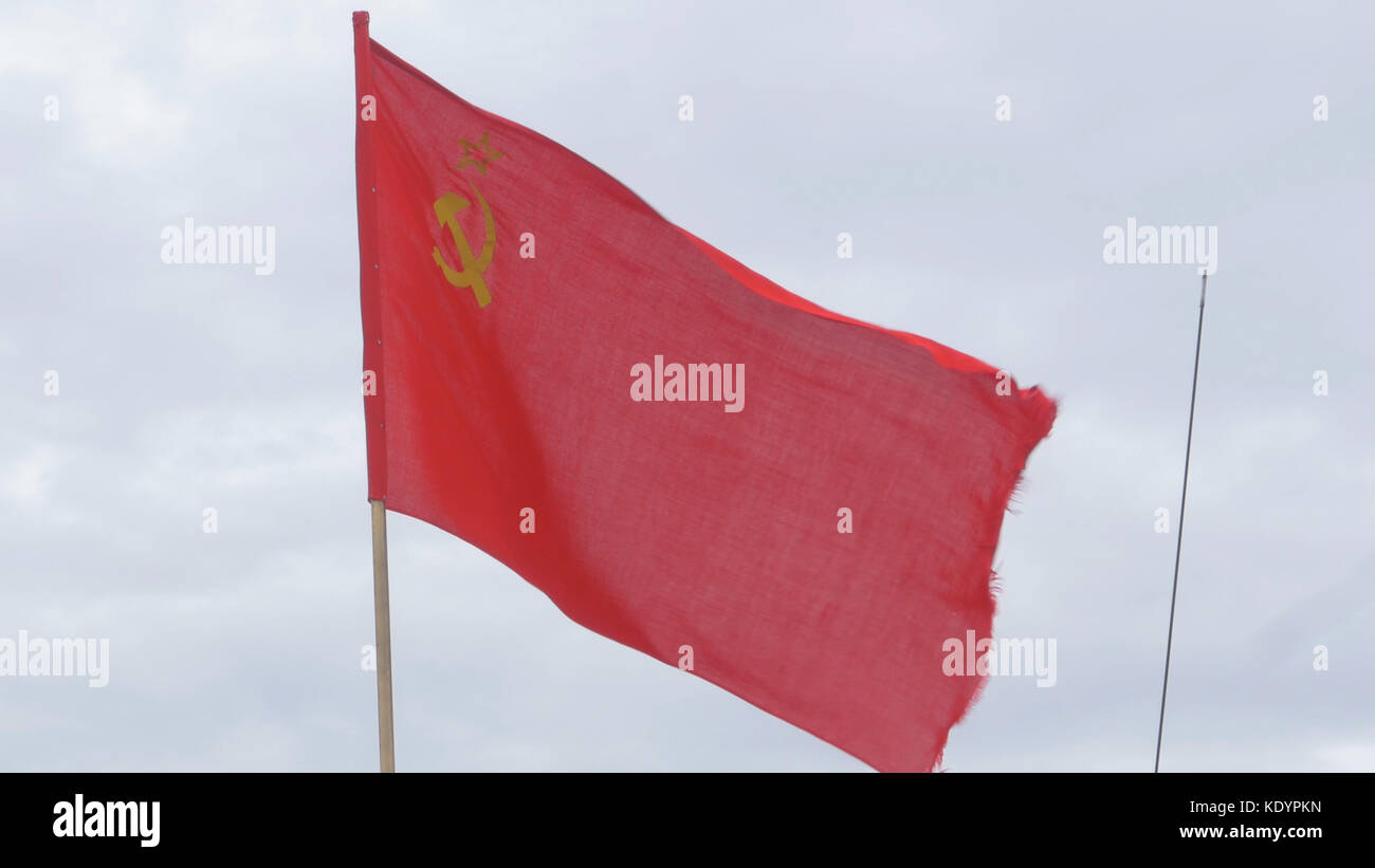 The flag of the USSR developing in the wind on a flagpole in a windy ...