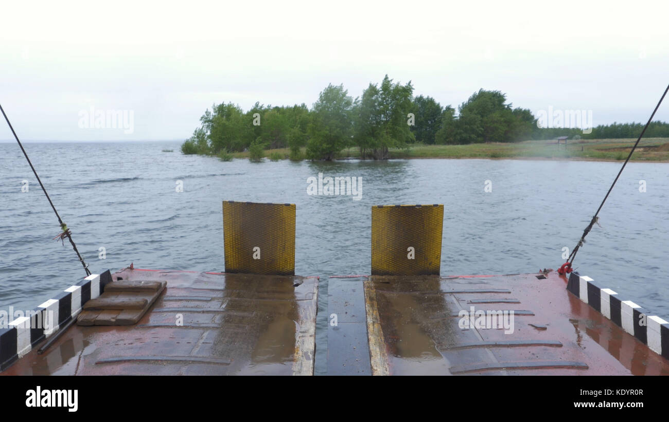 Ferry boat beach and a river. Ferry approaching with open ramp to El ...
