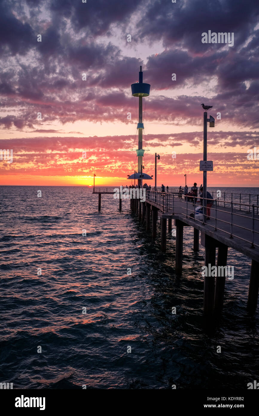 People enjoy a gorgeous sunset at the seaside on Adelaide's Brighton ...