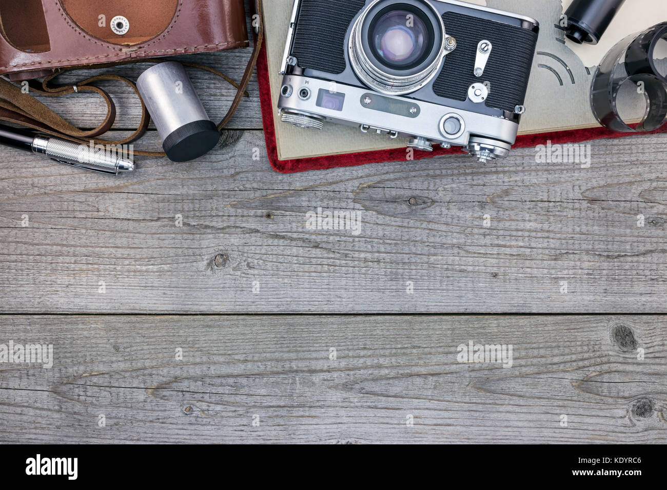 retro camera, pen, negative films and photo album on wooden table flat ...