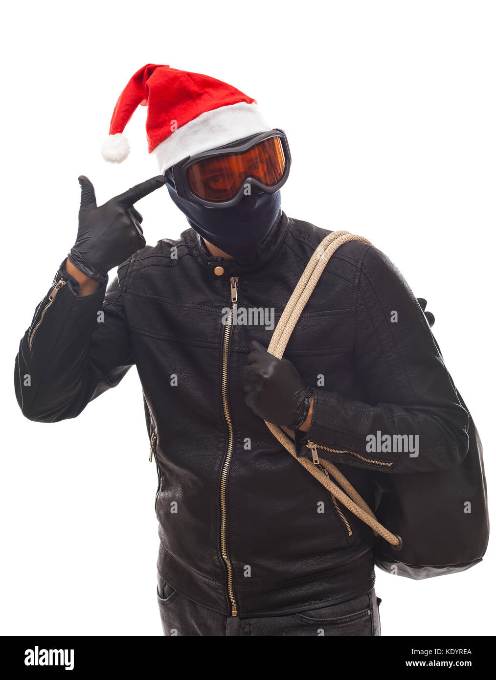 Masked burglar with santa claus cap holding his sack, posing on ...