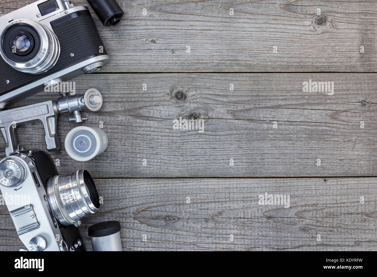 vintage still cameras on grunge wooden table background Stock Photo - Alamy