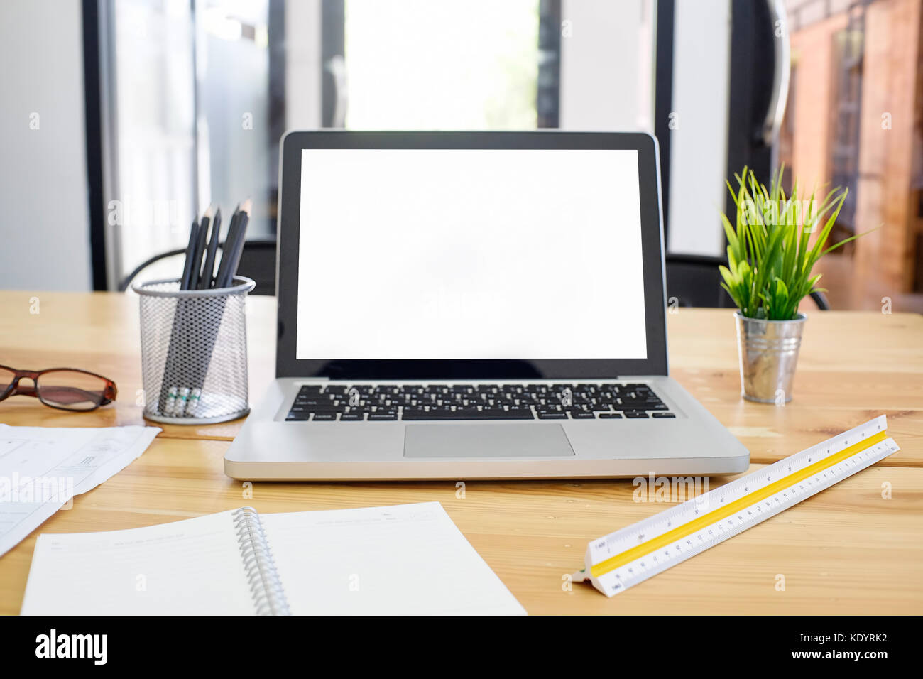 Laptop computer on architecture desk with empty screen Stock Photo - Alamy