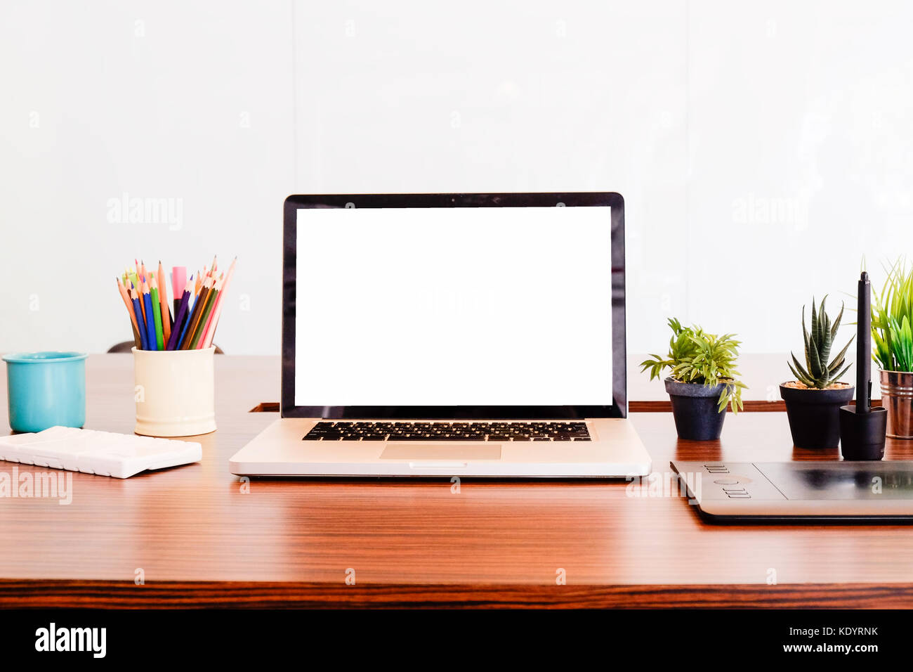 Laptop computer on workspace and other office gadget, empty screen ...