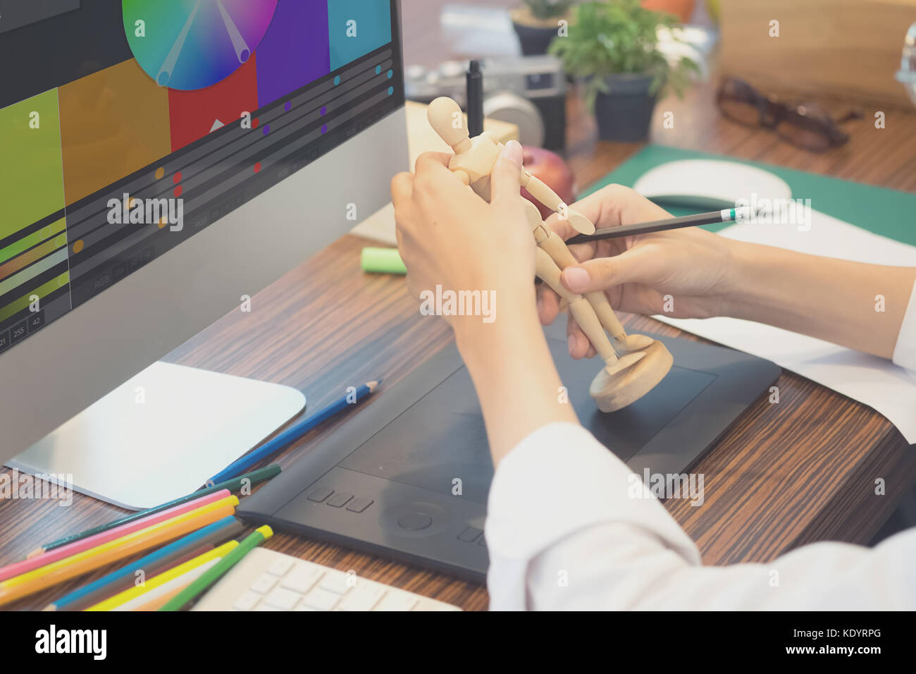 Artist working on creative desk with wood model and computer Stock ...