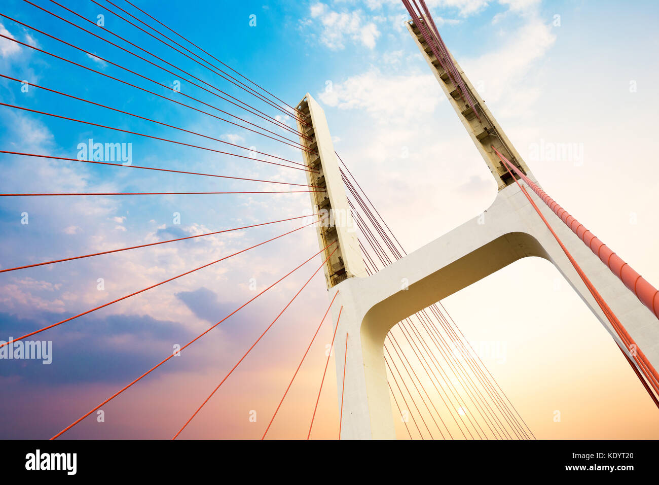 Modern bridge cables, twilight landscape Stock Photo - Alamy