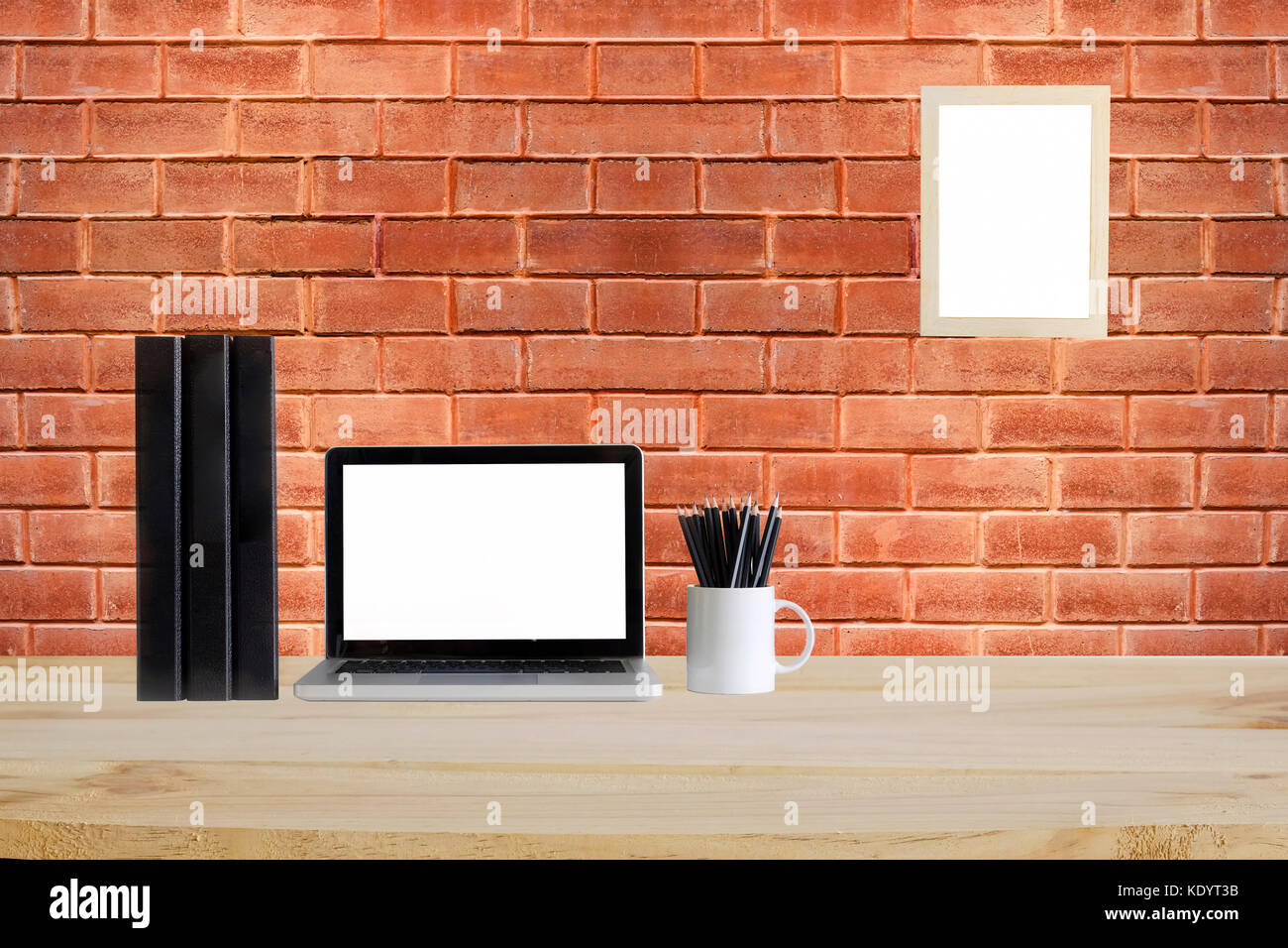 Laptop computer ,file folder document, pencil and photo frame on ...