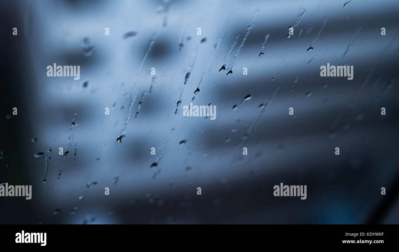 Window with raindrops over looking a city Stock Photo - Alamy