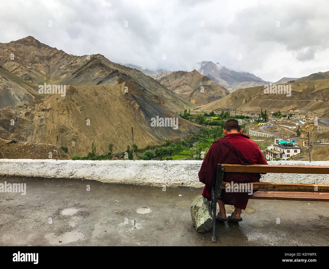 Young monk sitting overlooking the Himalayas Stock Photo - Alamy