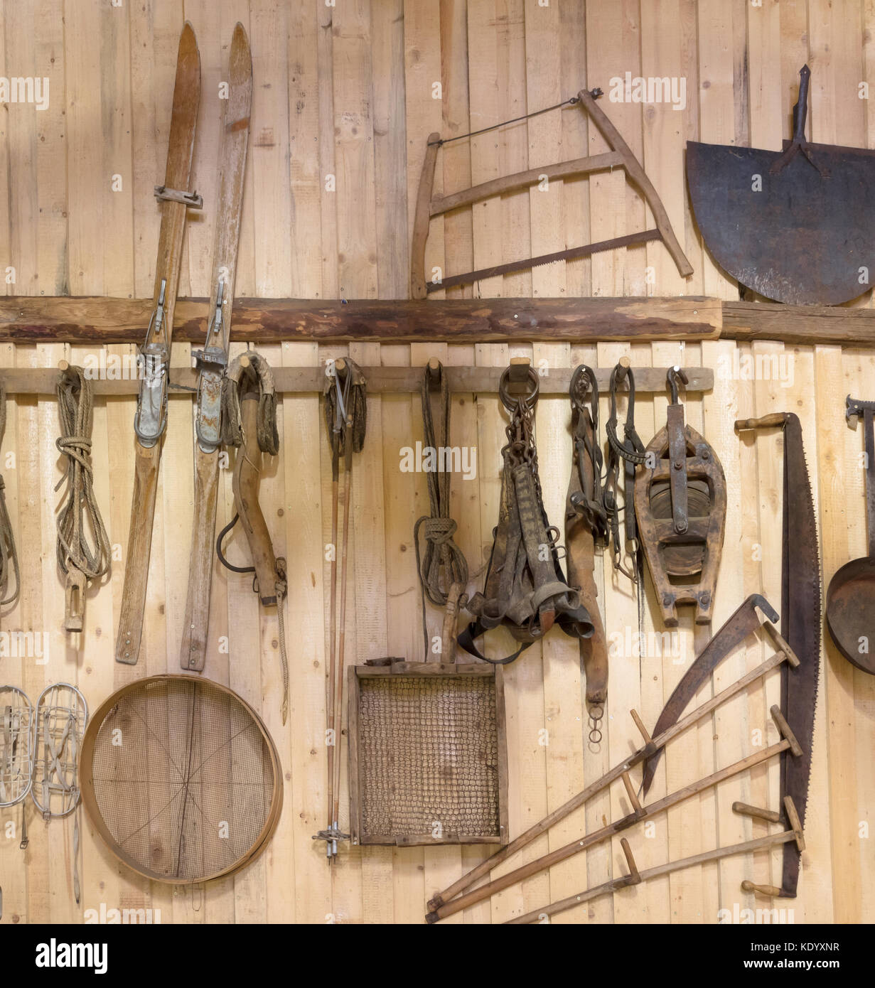 Old tools and vintage items hanging in an Austrian barn Stock Photo - Alamy