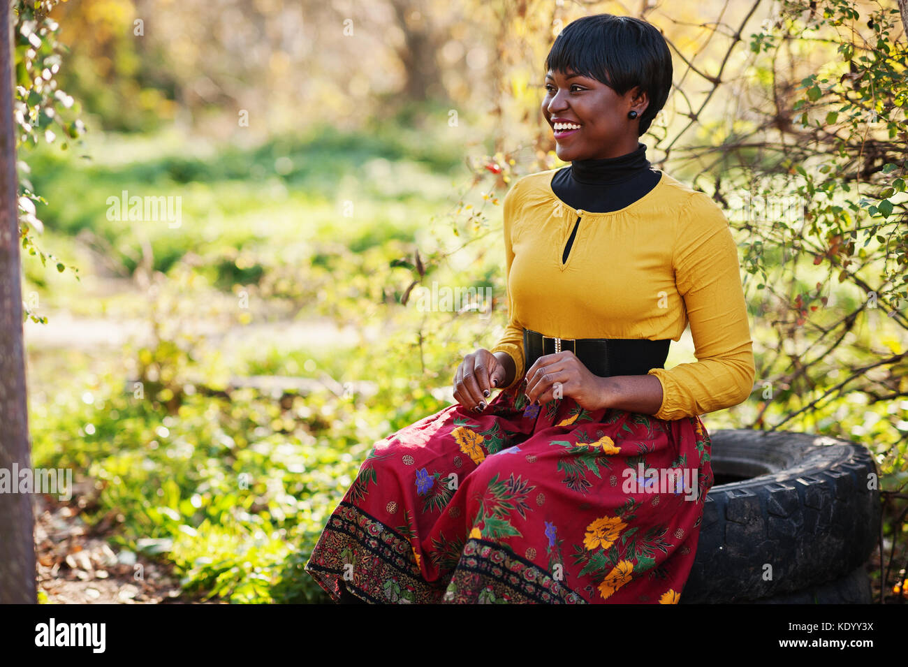 African american girl at yellow and red dress at golden autumn fall ...