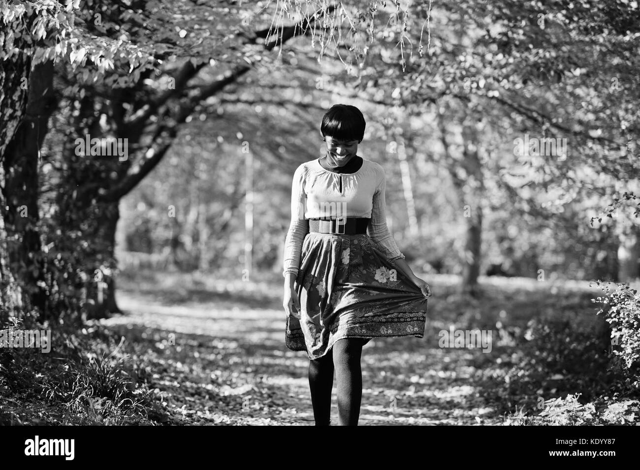 African american girl at yellow and red dress at golden autumn fall ...