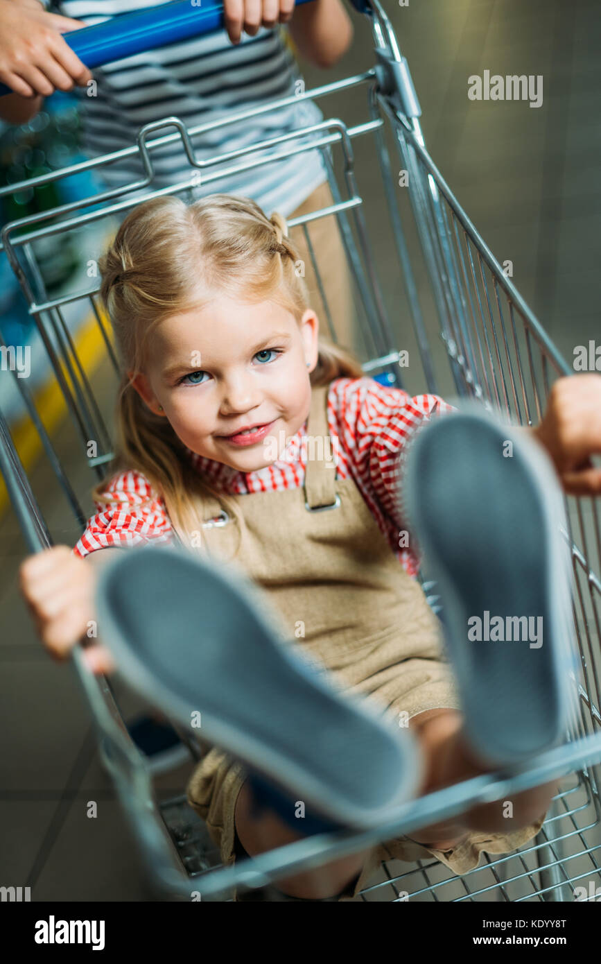 little kid in shopping cart Stock Photo - Alamy