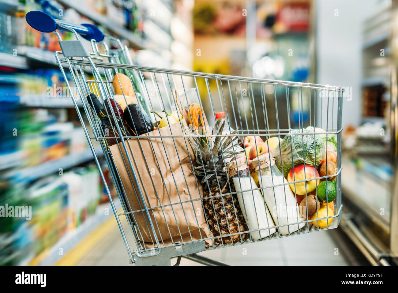 shopping cart with purchases in supermarket Stock Photo - Alamy