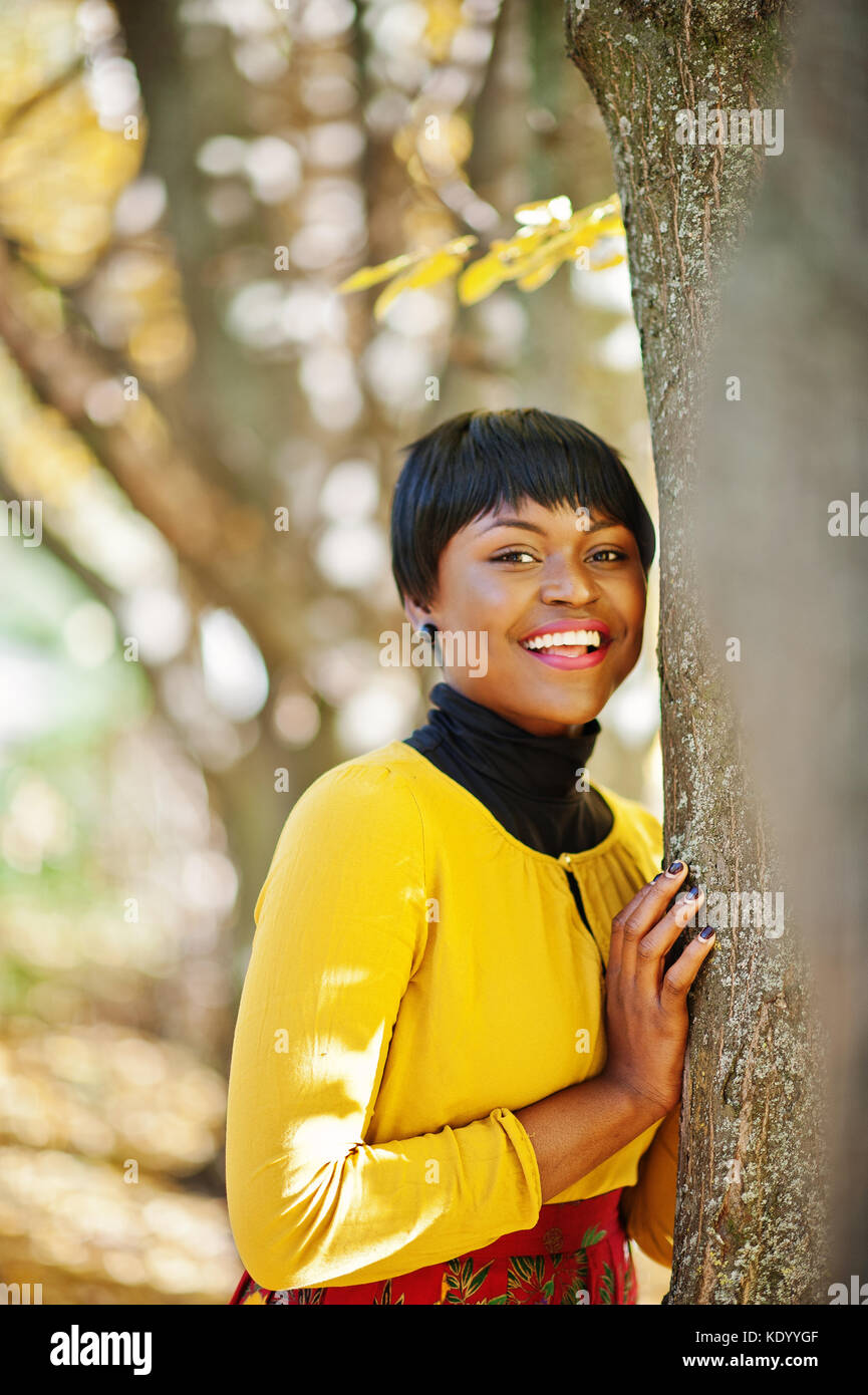African american girl at yellow and red dress at golden autumn fall ...