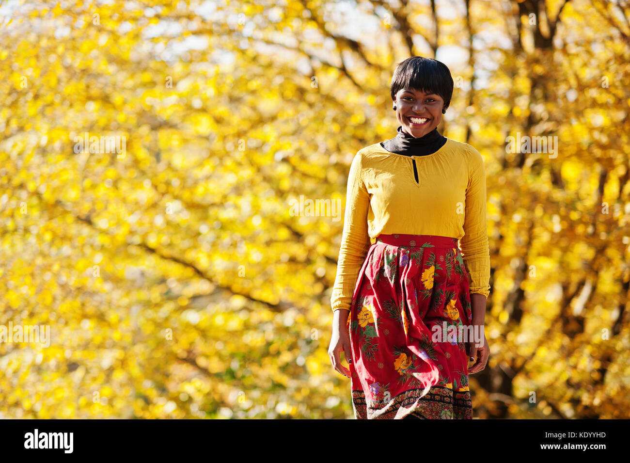 African american girl at yellow and red dress at golden autumn fall ...