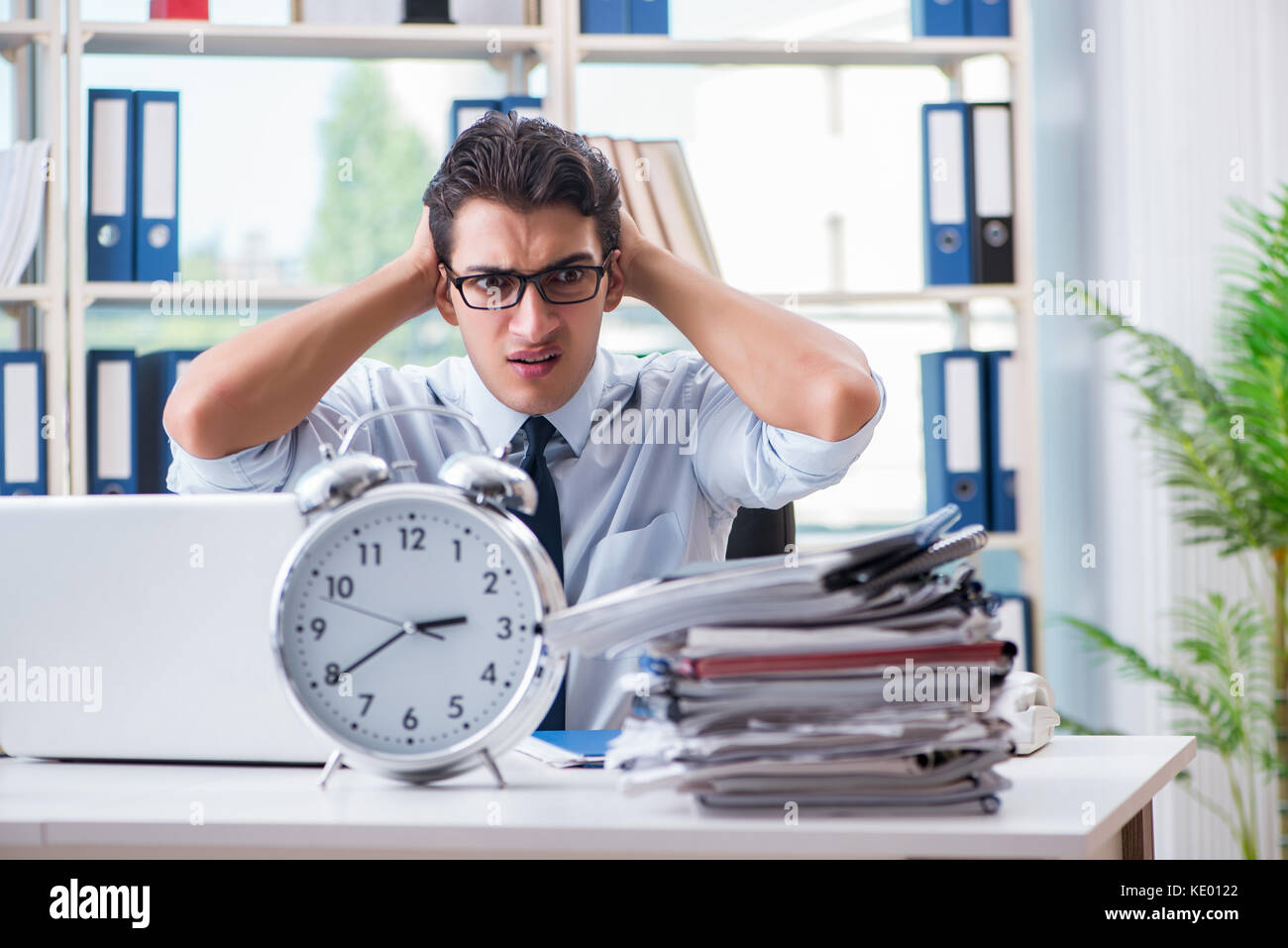 Businessman missing deadline for deliverables in office Stock Photo - Alamy