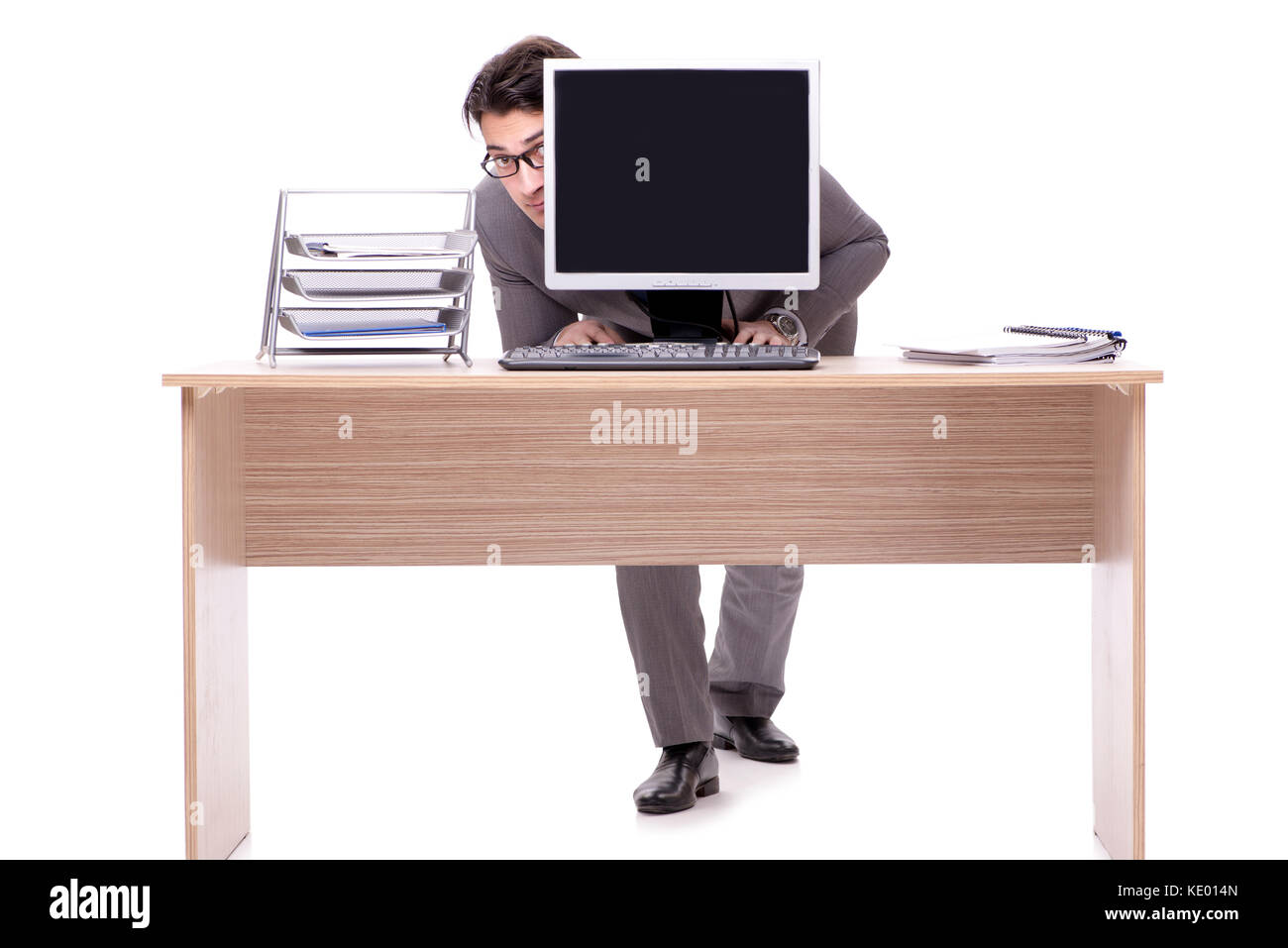 Businessman hiding in the office isolated on white Stock Photo - Alamy