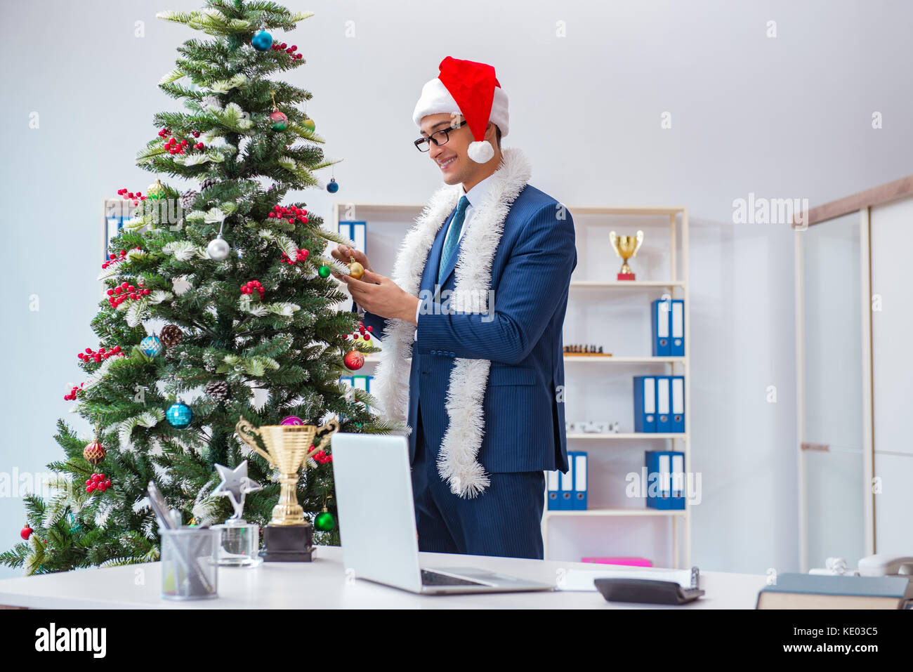 Businessman celebrating christmas holiday in the office Stock Photo - Alamy