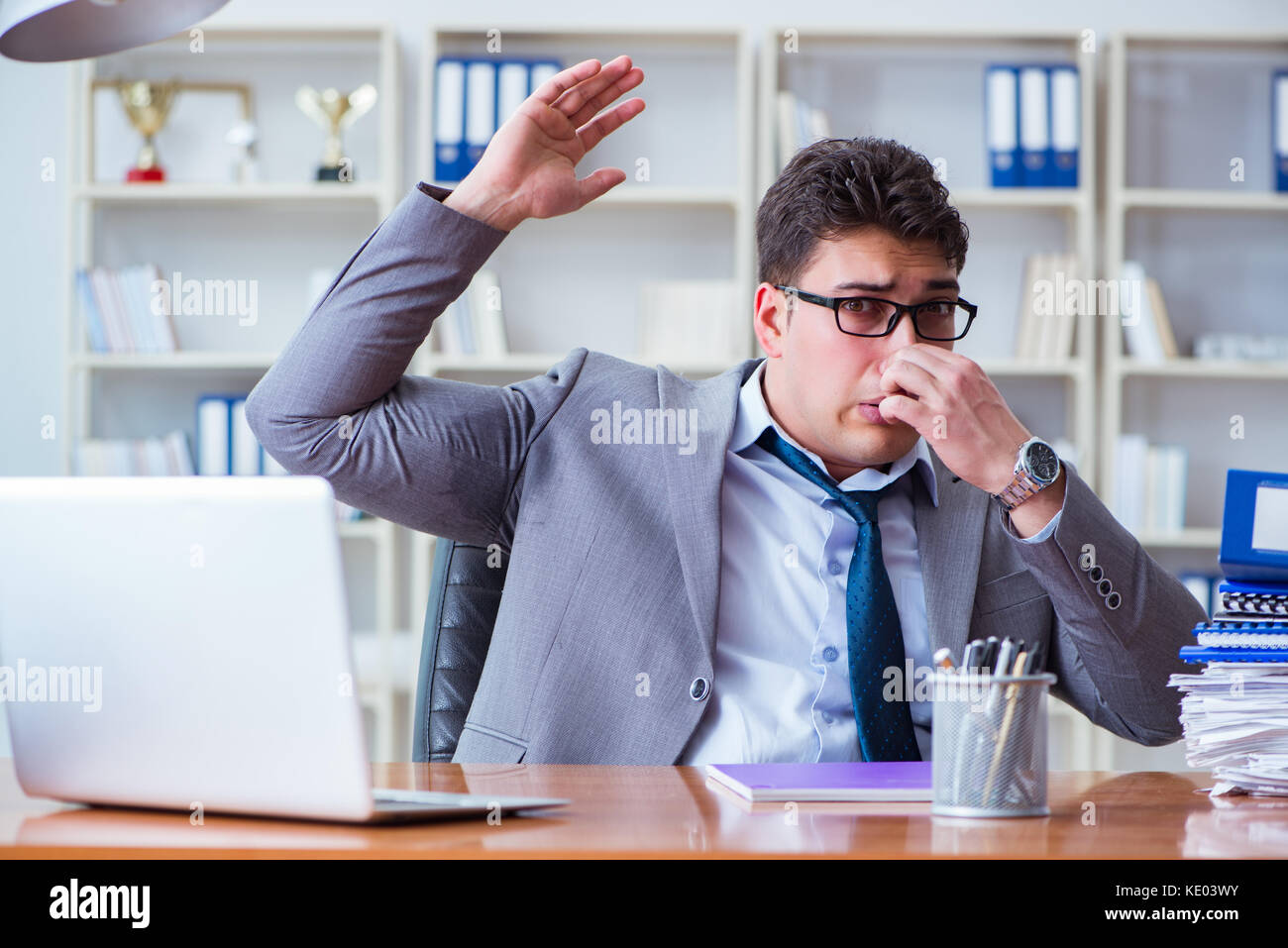 Businessman sweating excessively smelling bad in office at workplace ...