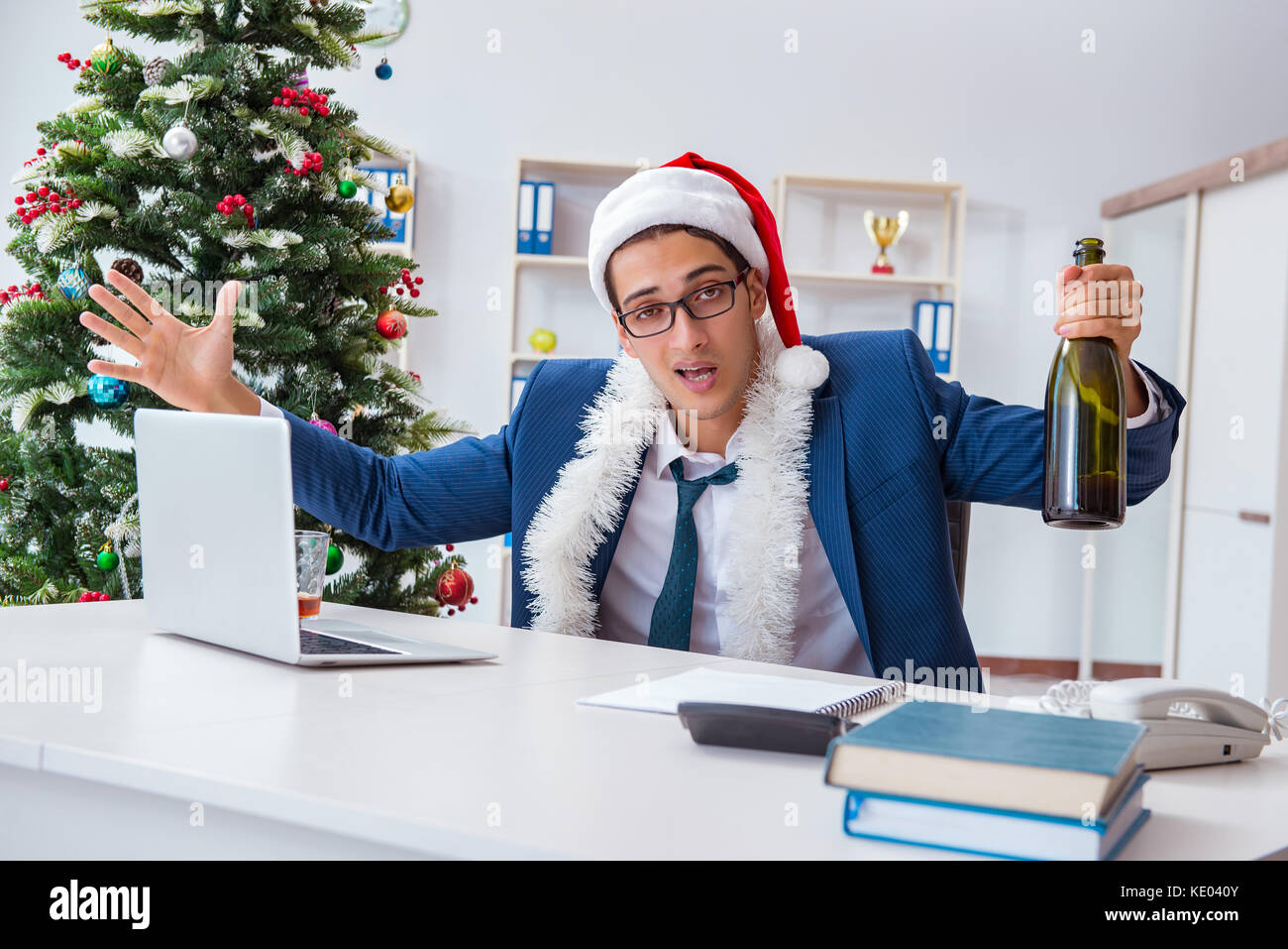 Businessman celebrating christmas holiday in the office Stock Photo - Alamy