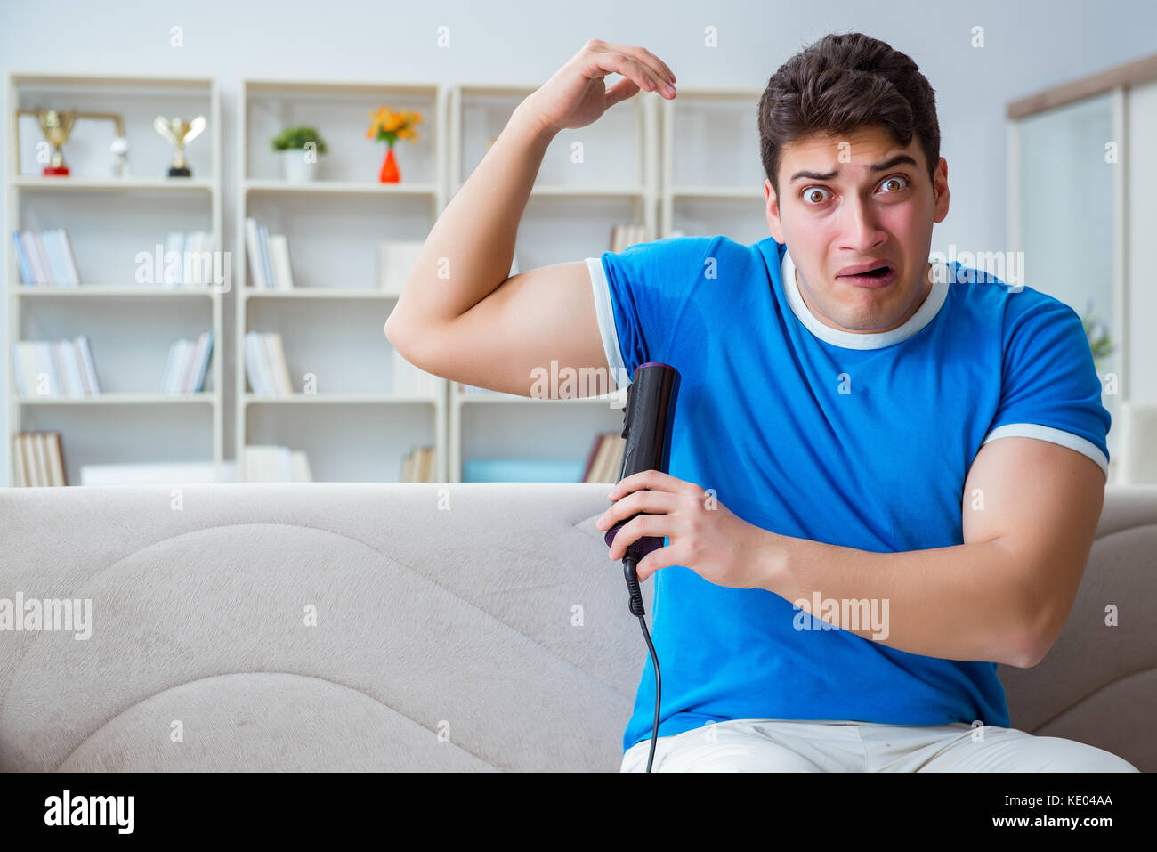 Man sweating excessively smelling bad at home Stock Photo - Alamy