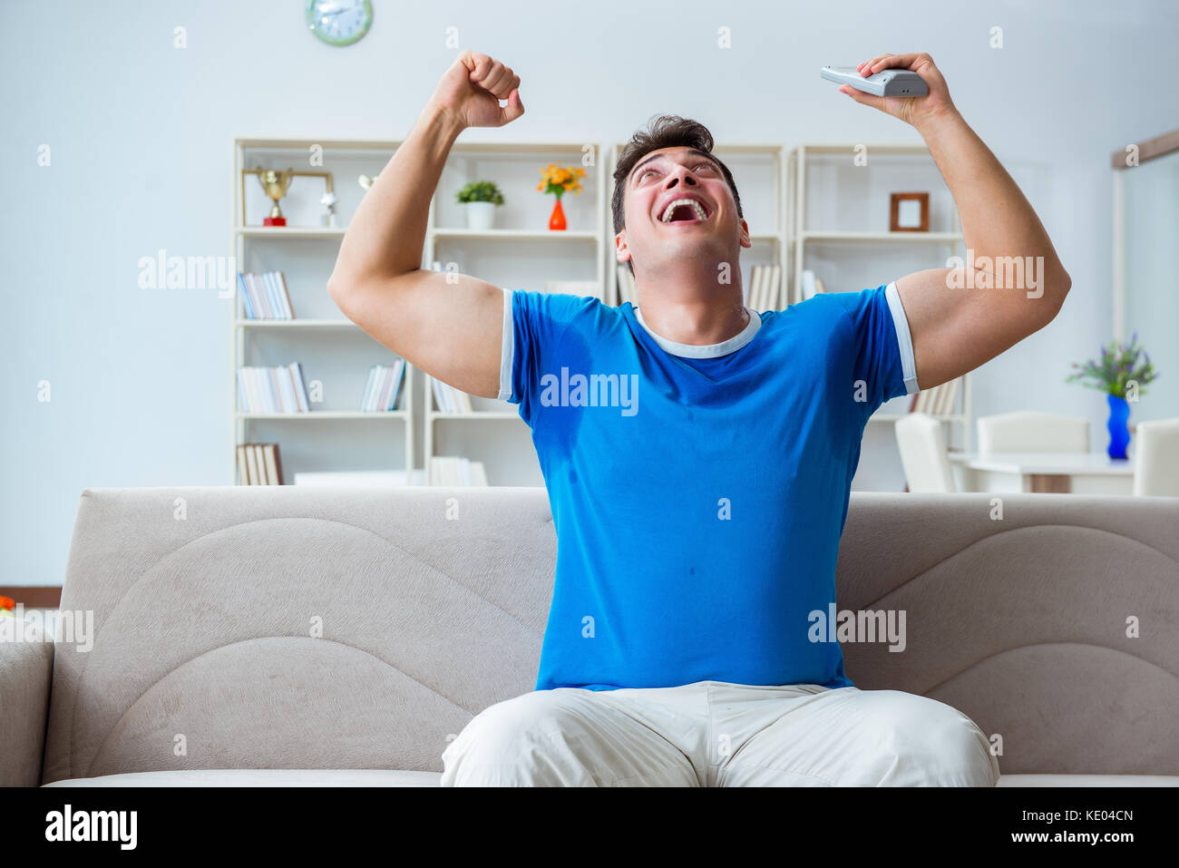 Man sweating excessively smelling bad at home Stock Photo - Alamy