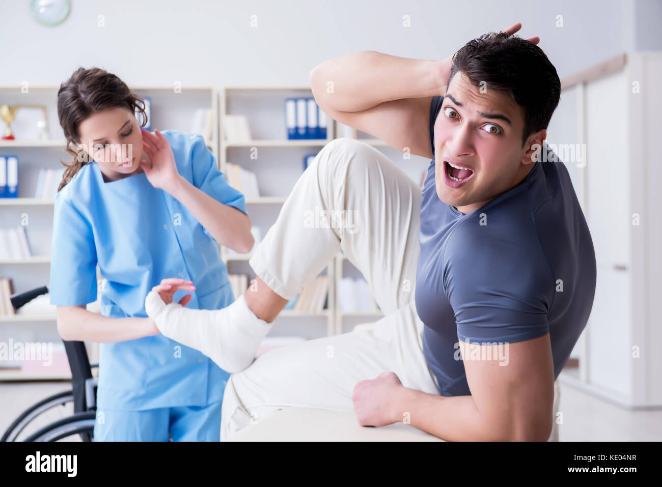 Doctor and patient during check-up for injury in hospital Stock Photo ...