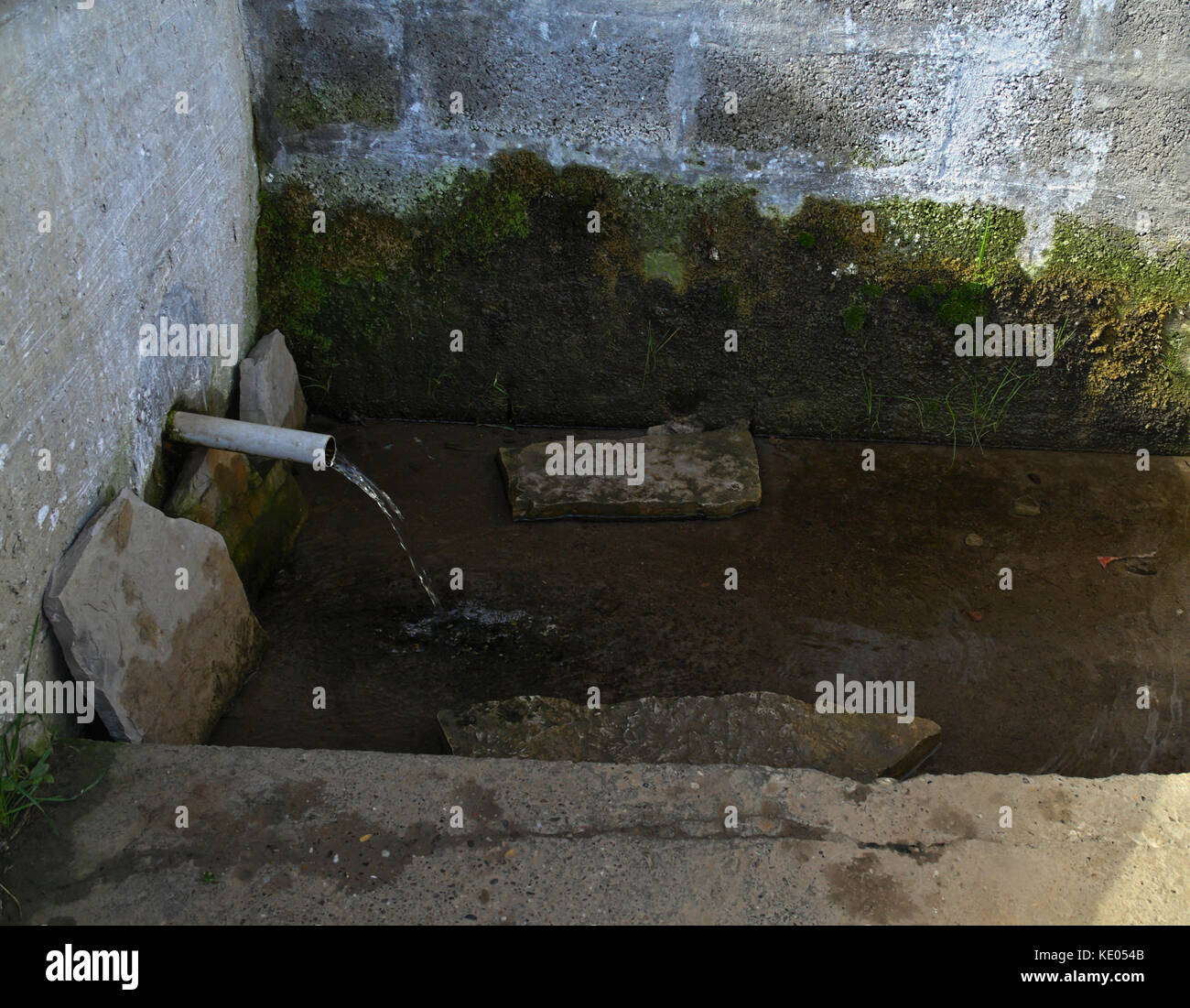 Simple fountain flowing with clear mountain water Stock Photo - Alamy