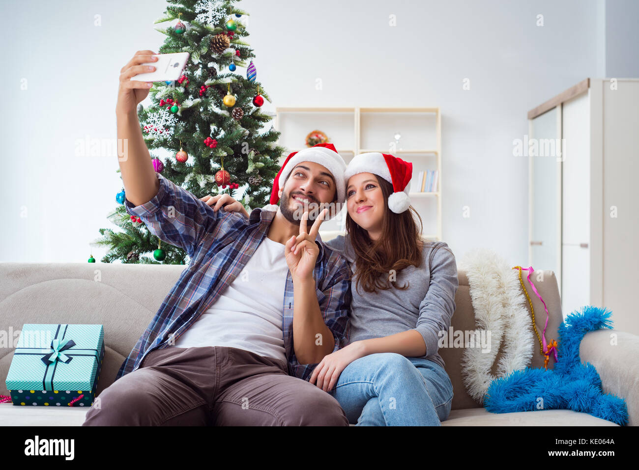 Young pair taking selfies during christmas Stock Photo - Alamy