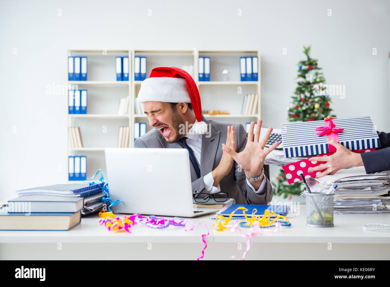 Young businessman celebrating christmas in the office Stock Photo - Alamy