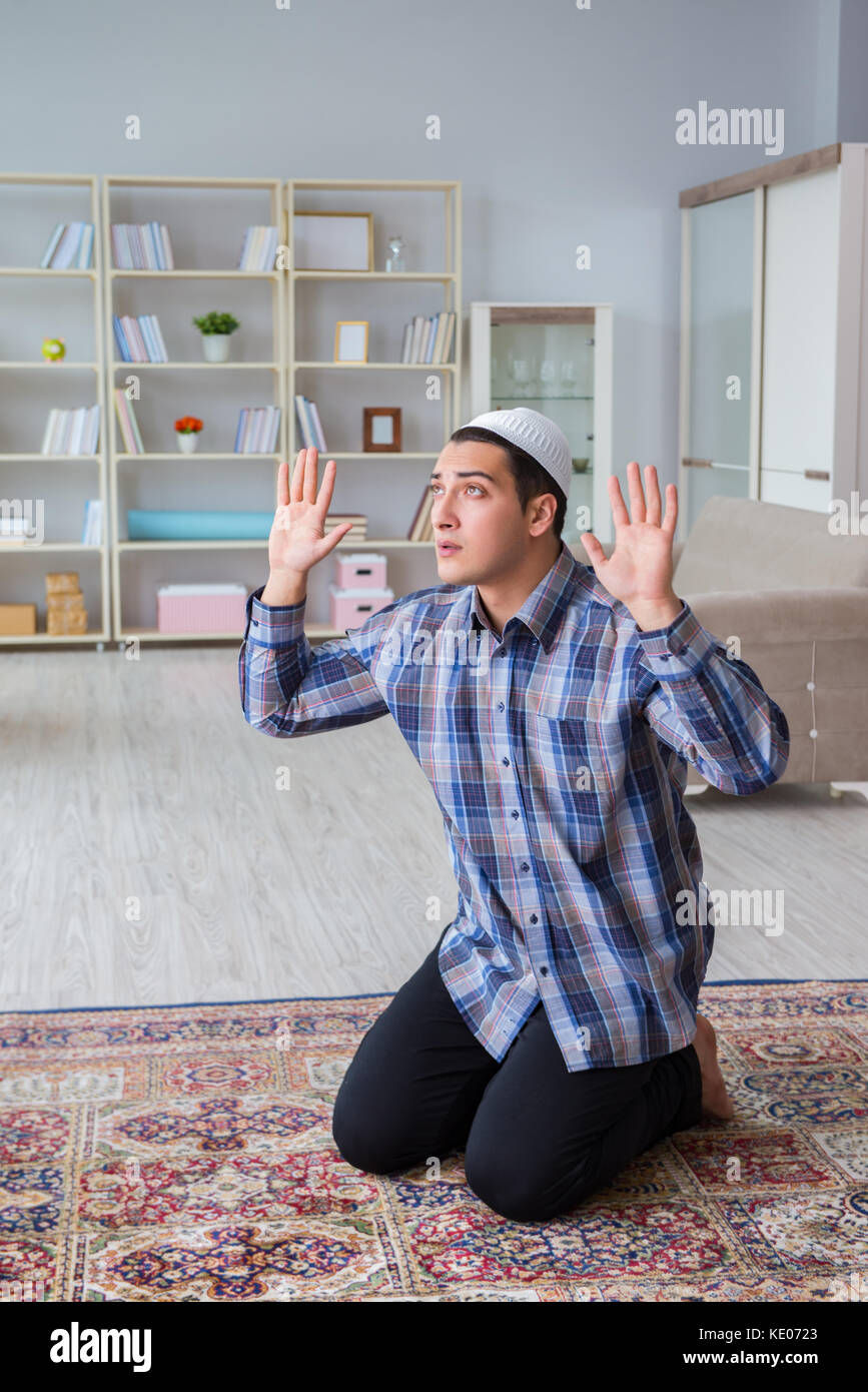 Young muslim man praying at home Stock Photo - Alamy