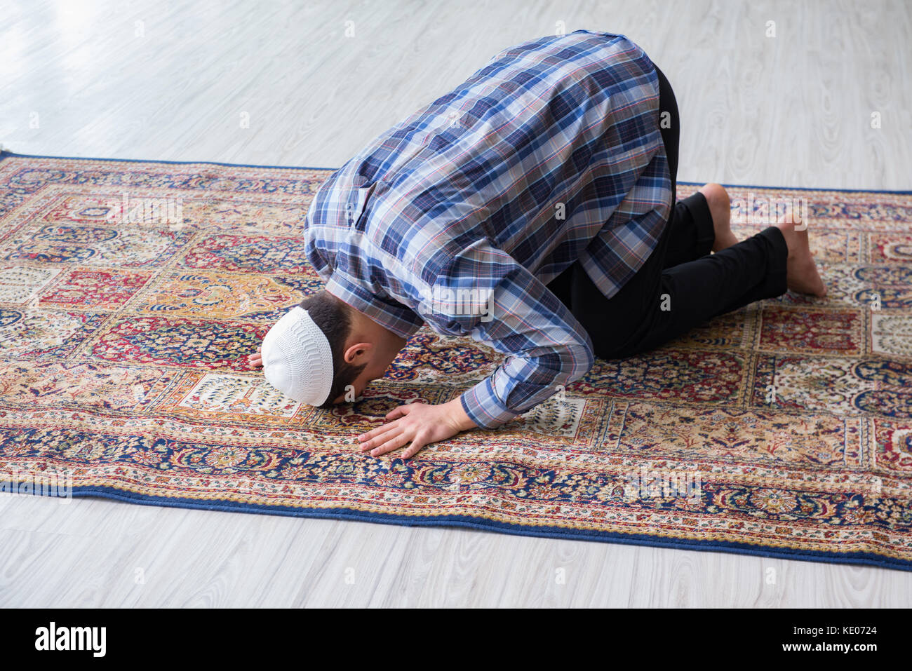 Young muslim man praying at home Stock Photo - Alamy