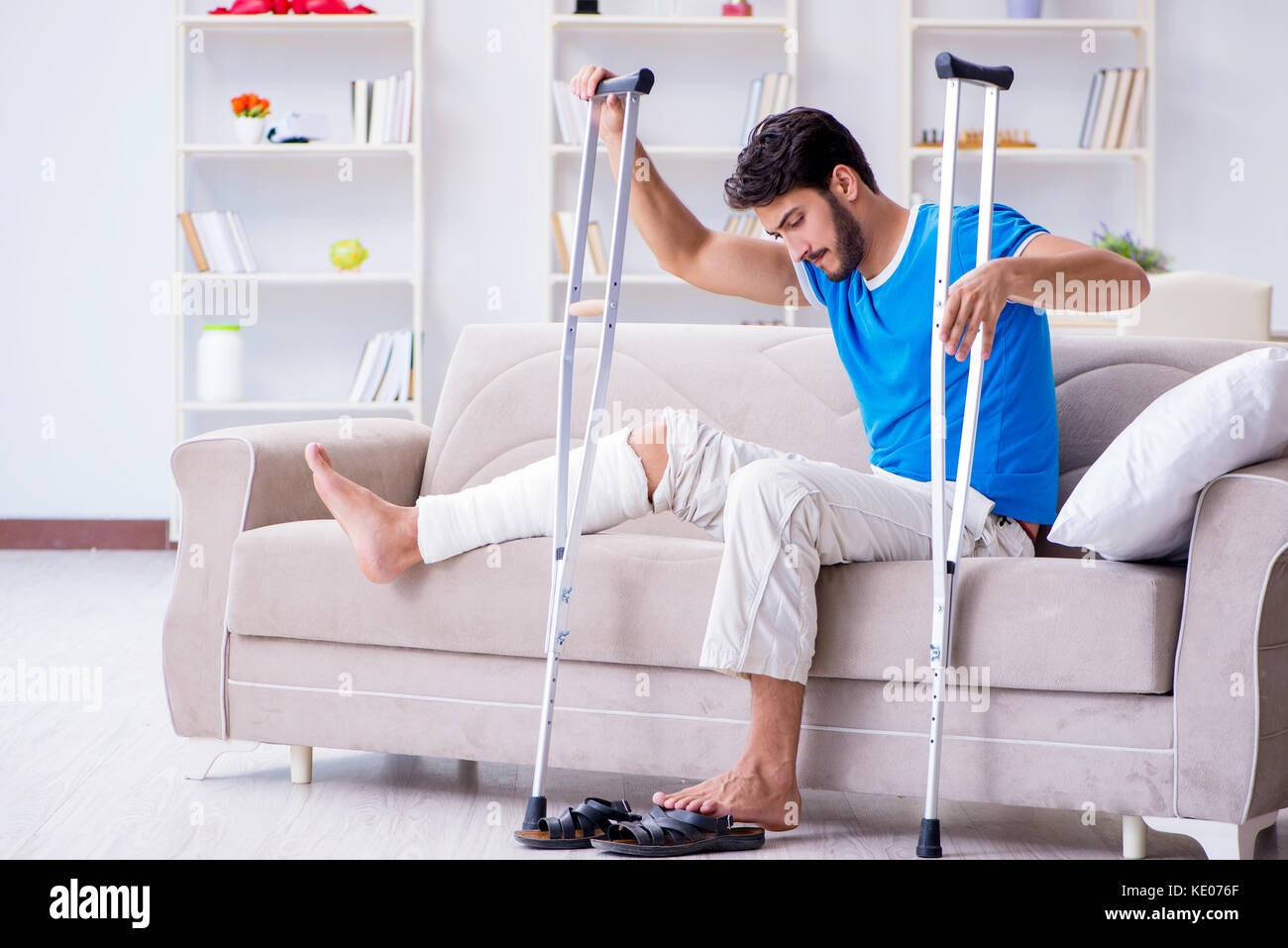 Injured young man recovering at home Stock Photo - Alamy