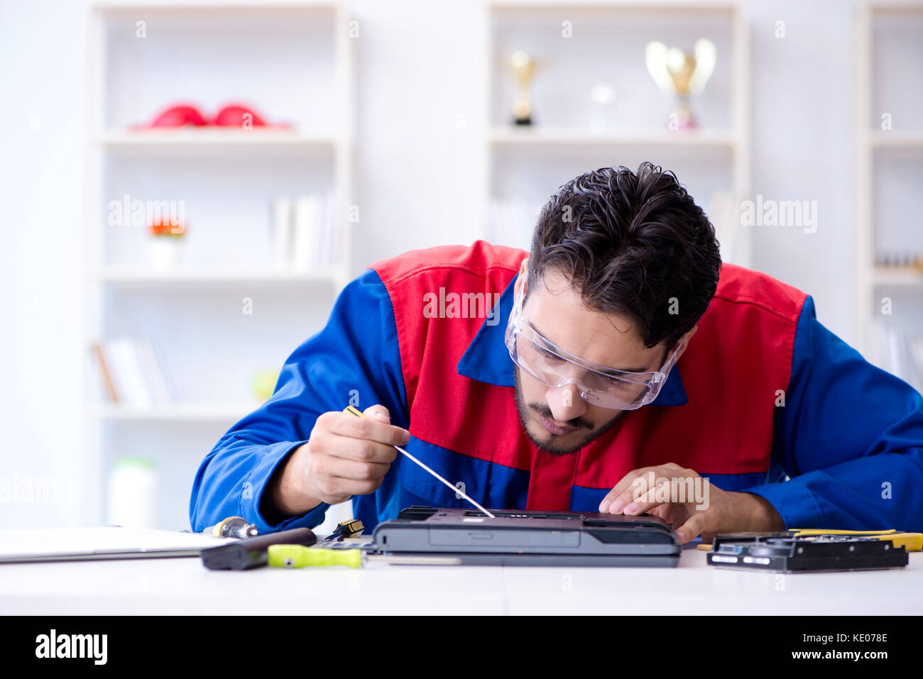 Repairman working in technical support fixing computer laptop ...