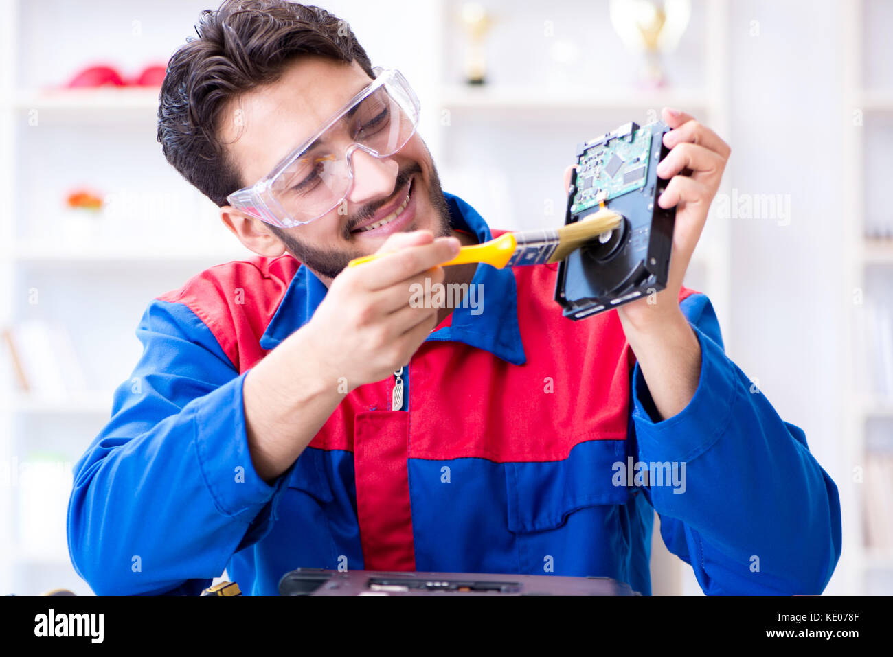 Repairman working in technical support fixing computer laptop ...