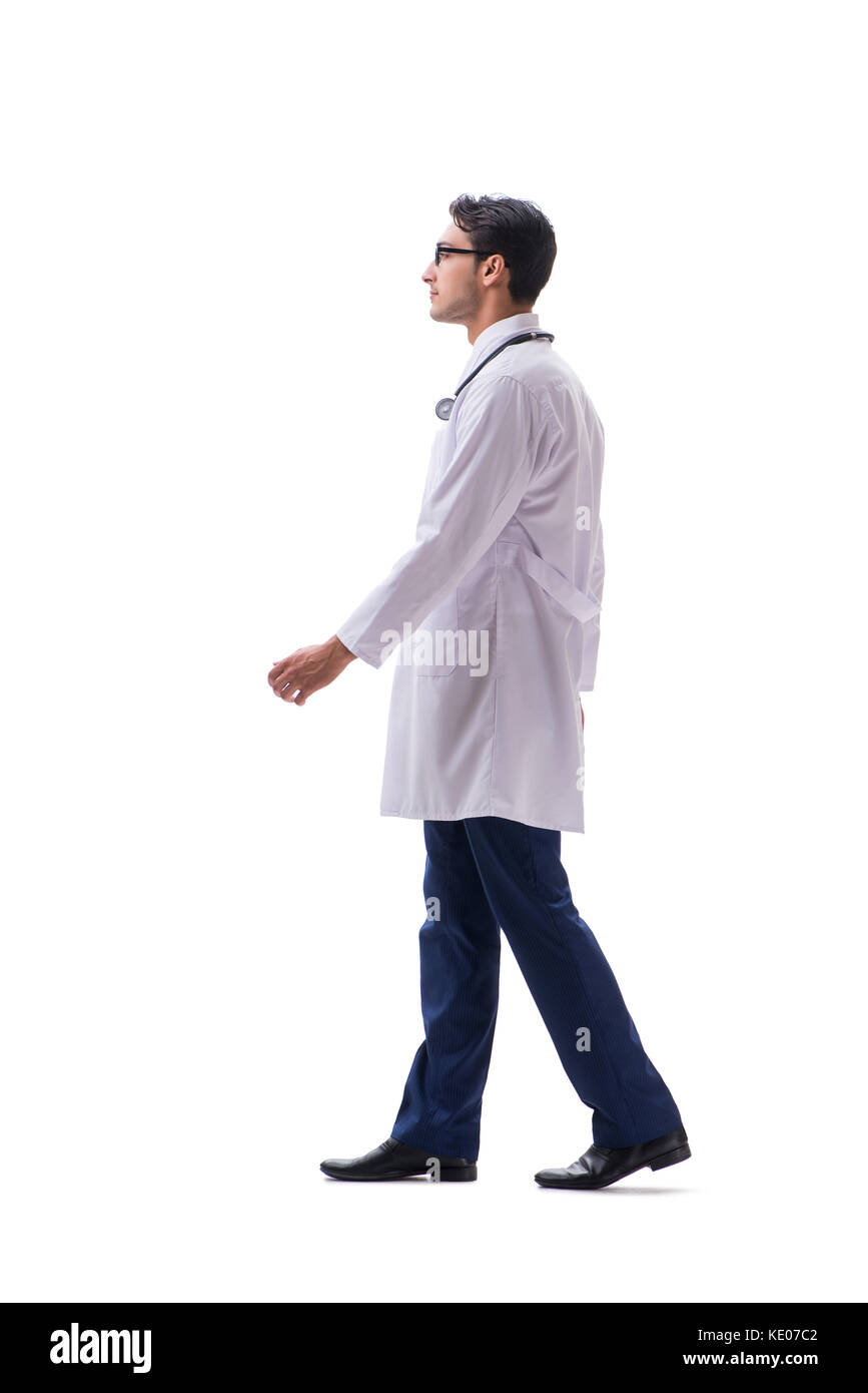 Young doctor physician standing walking isolated on white background ...