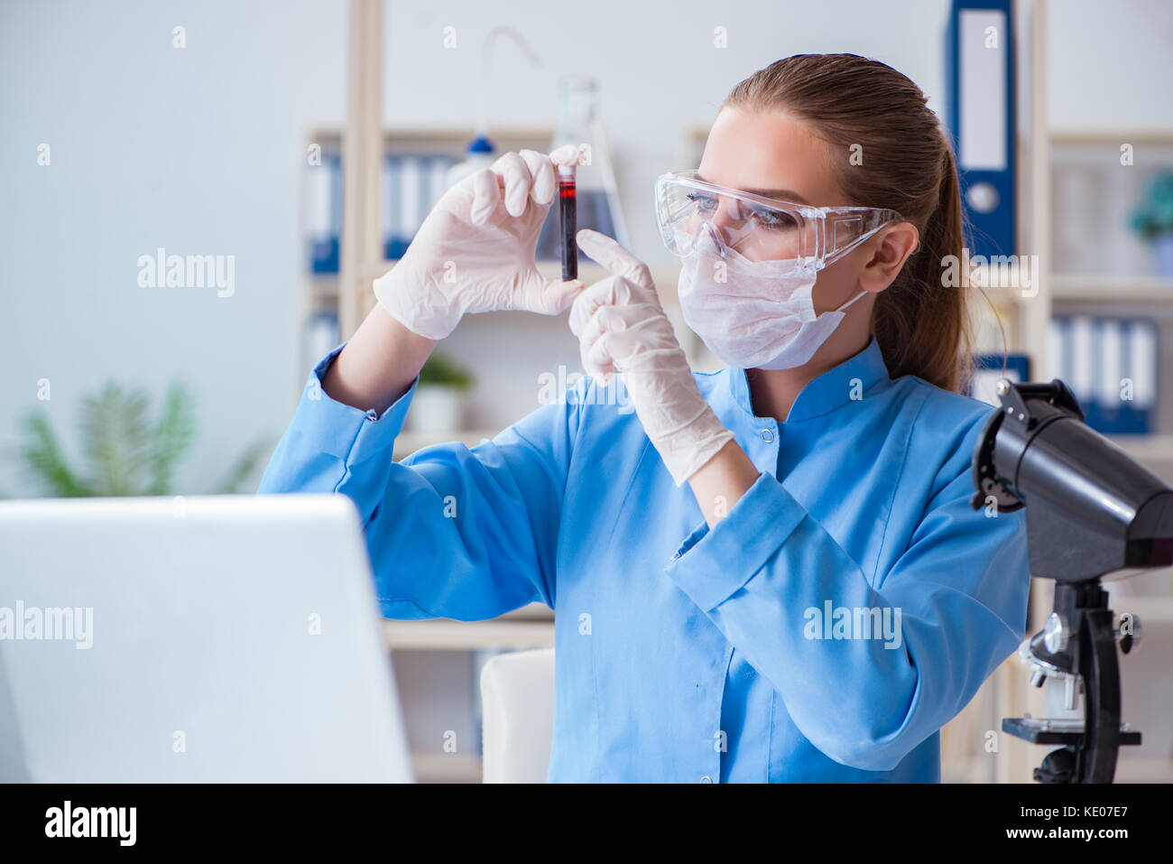Female scientist researcher conducting an experiment in a laboratory ...