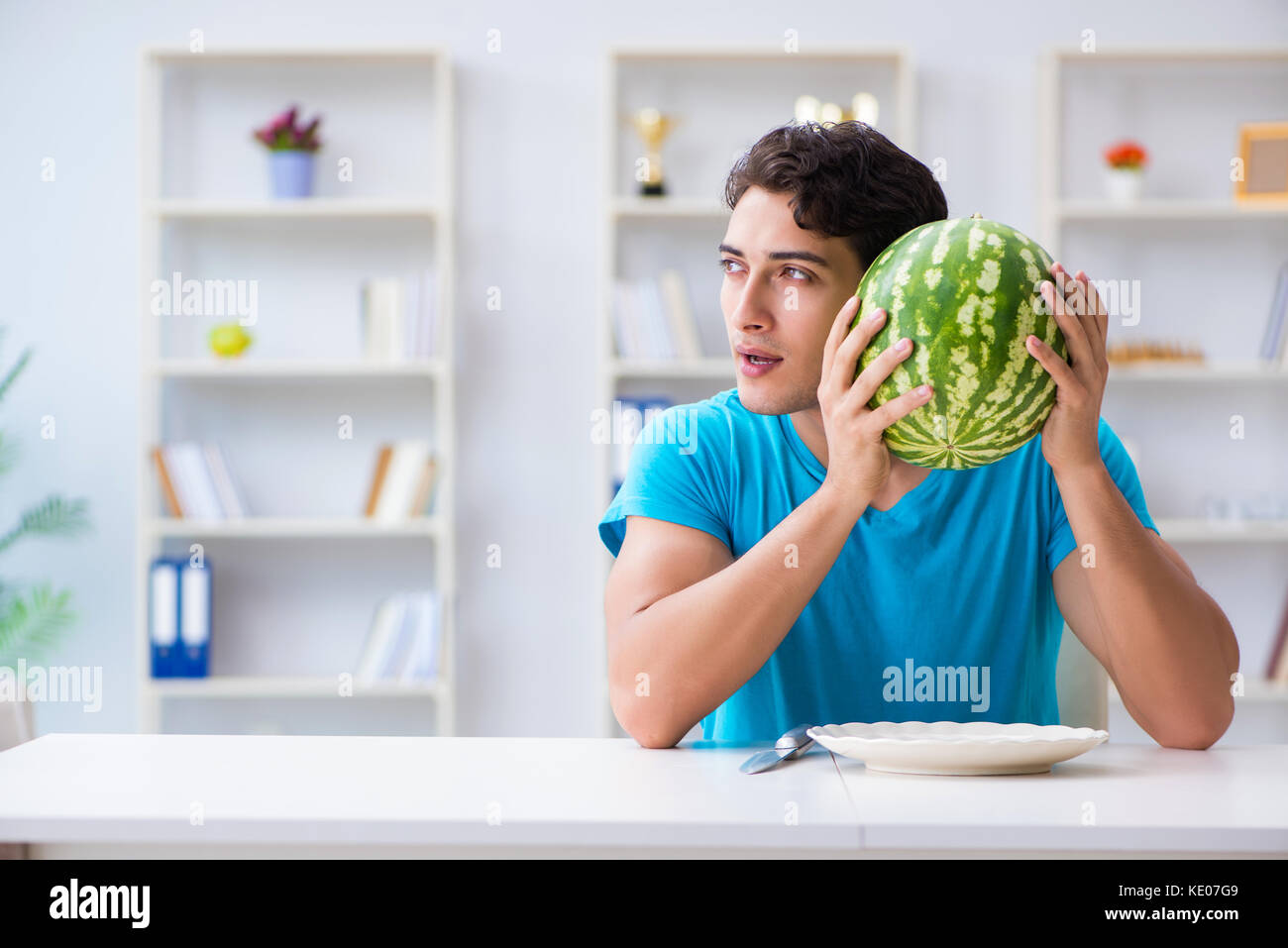 Man eating watermelon at home Stock Photo - Alamy