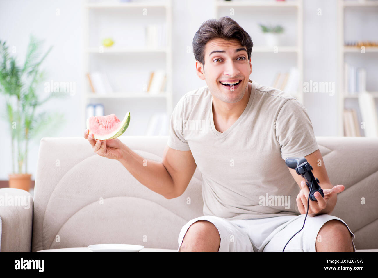 Man eating watermelon at home Stock Photo - Alamy
